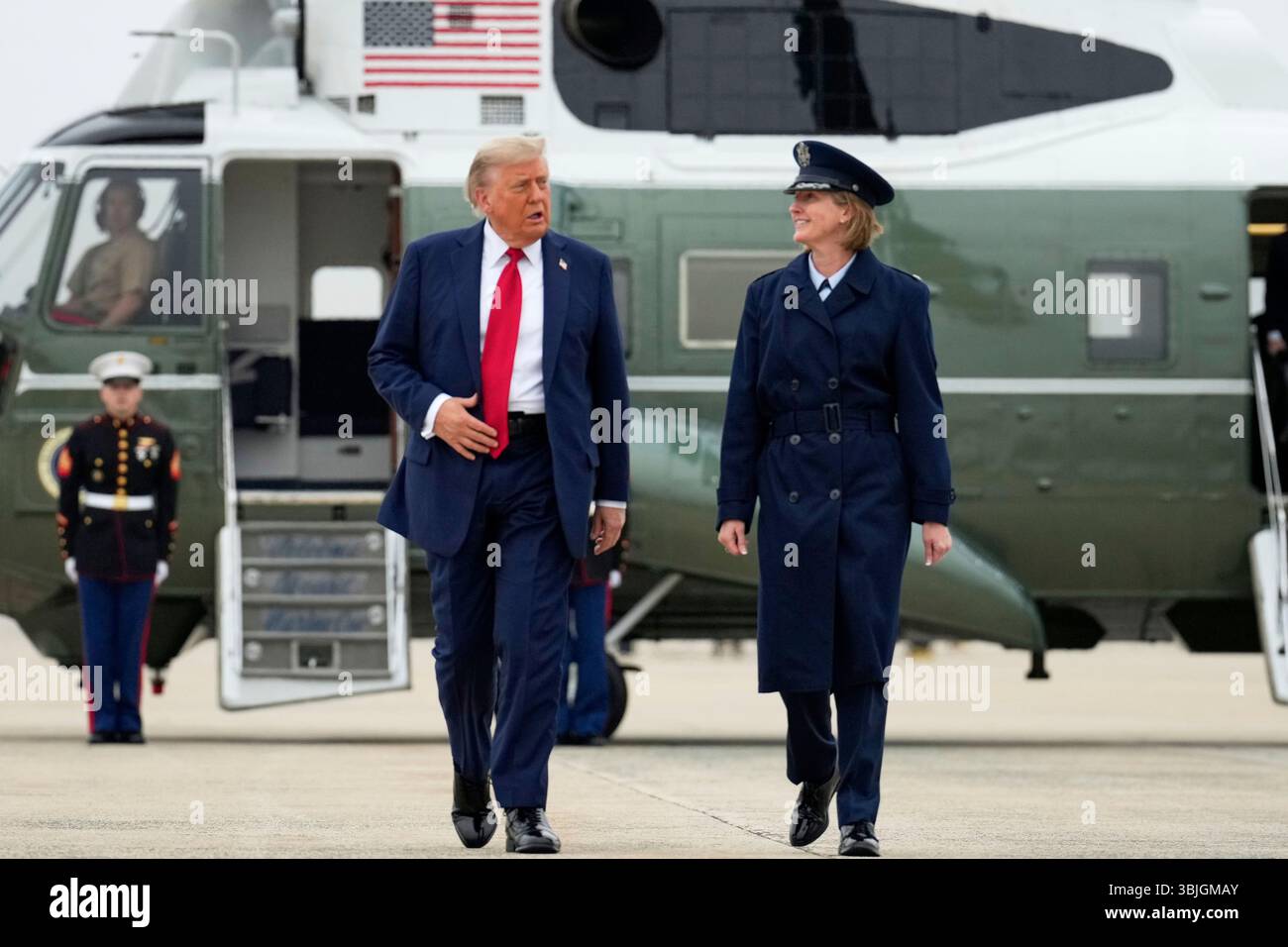 President Donald Trump, left, escorted by Air Force Col. Angela F ...