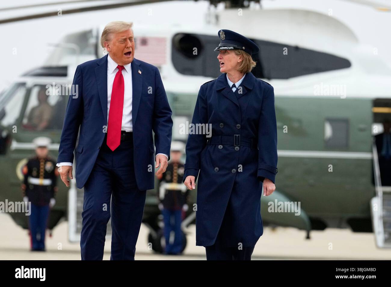 President Donald Trump, left, escorted by Air Force Col. Angela F ...