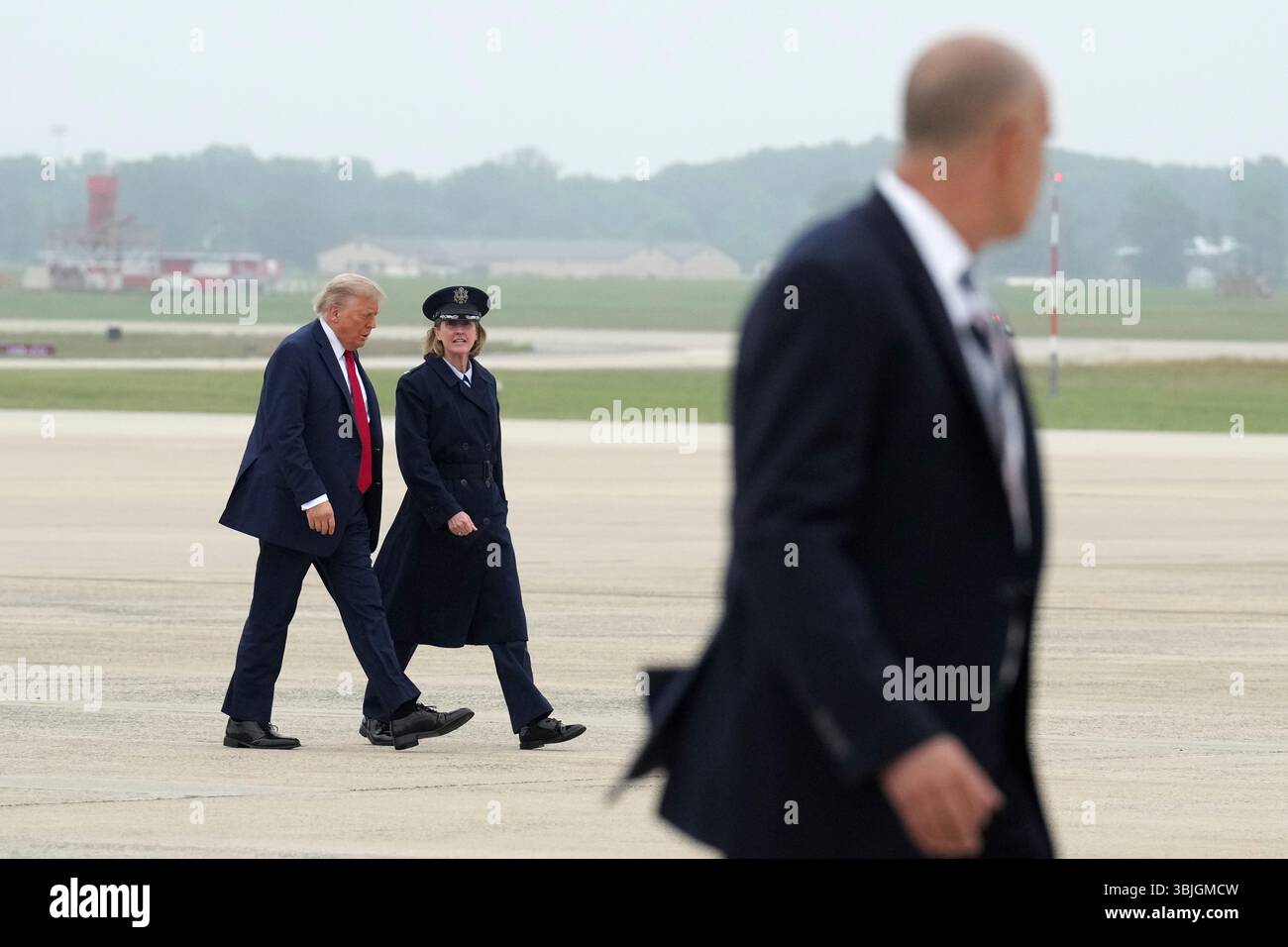 President Donald Trump, from left, escorted by Air Force Col. Angela F ...