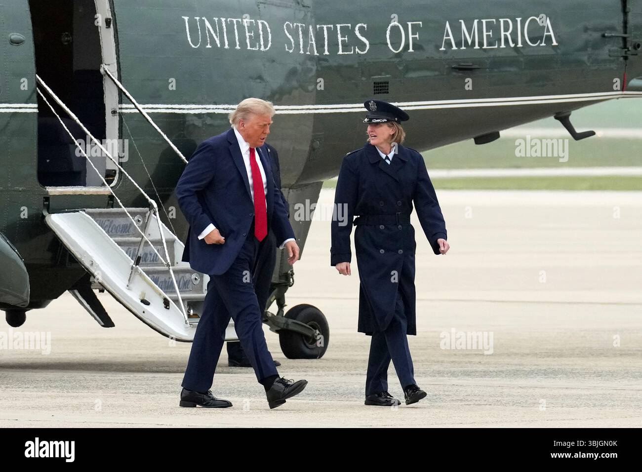 President Donald Trump, left, escorted by Air Force Col. Angela F ...