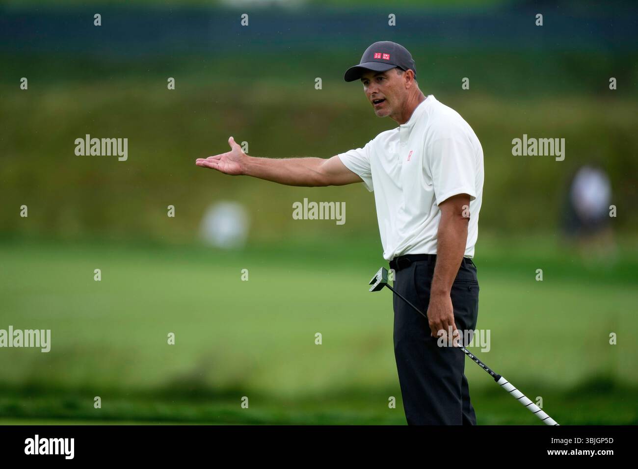 Adam Scott, of Australia, reacts after missing a putt on the 13th hole ...