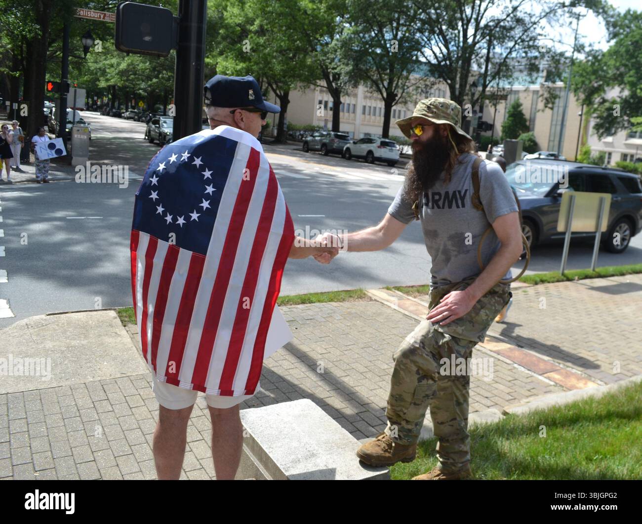Two men have a heated discussion at "No Kings Rally" in Raleigh in June ...