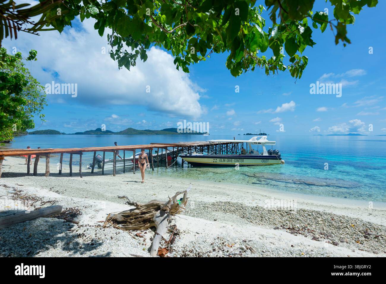 Sandy beach with pier and tourist boat in Raja Ampat, West Papua ...