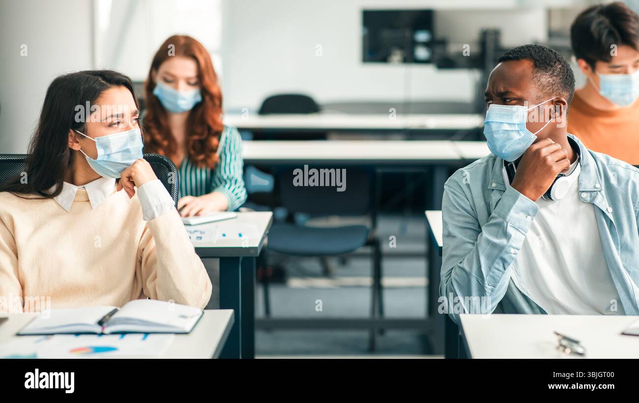 International students wearing medical masks and talking Stock Photo ...