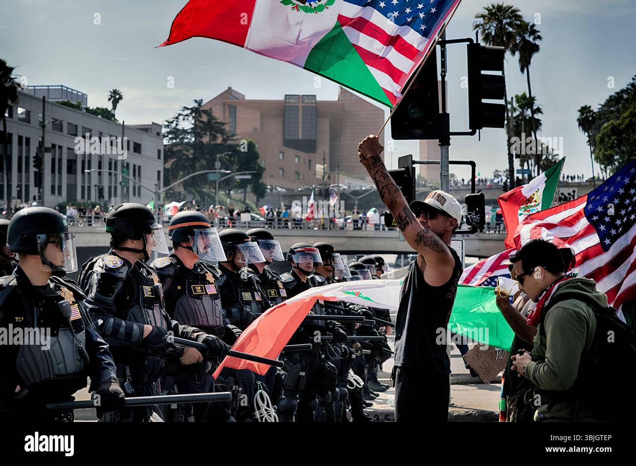Protesters wave flags against California Highway Patrol officers with ...