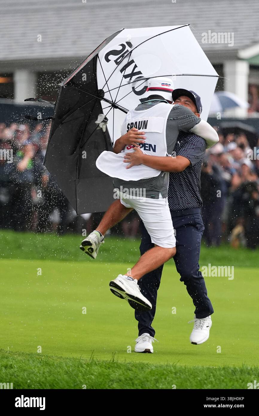 J.J. Spaun celebrates by hugging his caddie, Mark Carens, after making ...