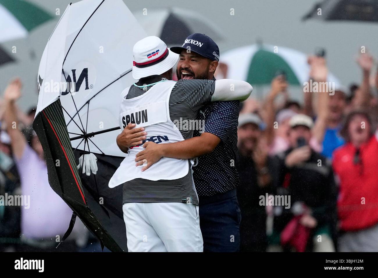 J.J. Spaun celebrates by hugging his caddie, Mark Carens, after making ...