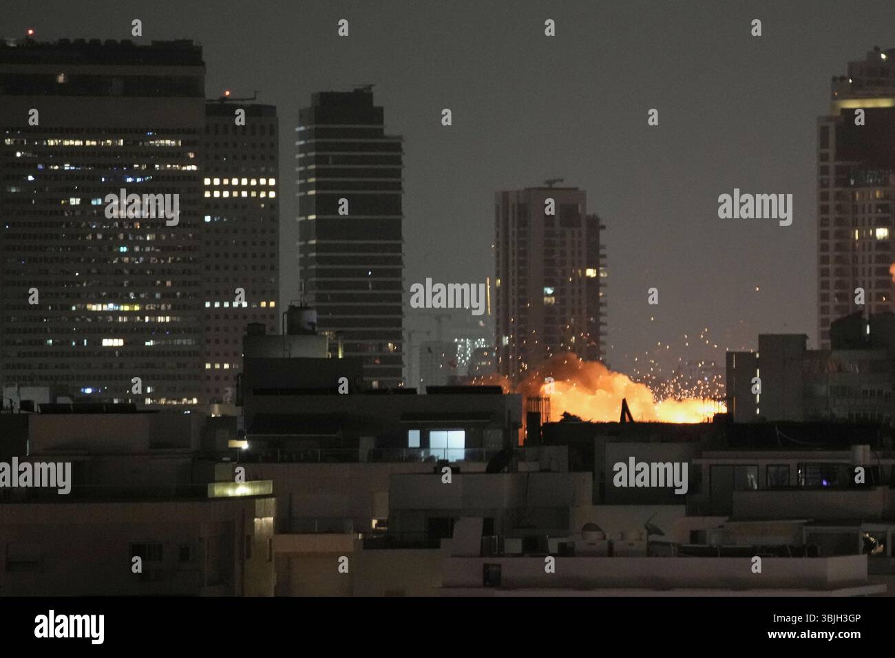 An explosion is seen during a missile attack in Tel Aviv, Israel ...