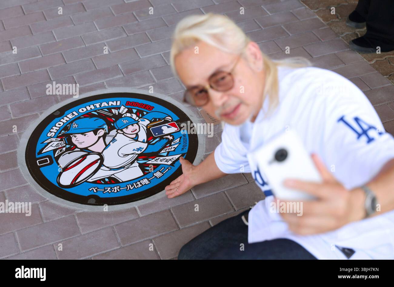 A manhole cover featuring Japanese MLB star Shohei OHtani is installed ...