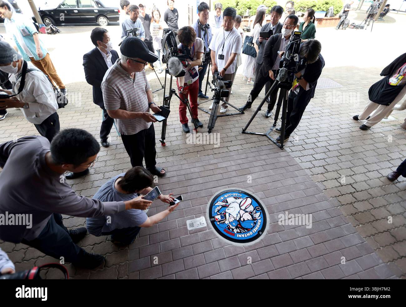 A manhole cover featuring Japanese MLB star Shohei OHtani is installed ...