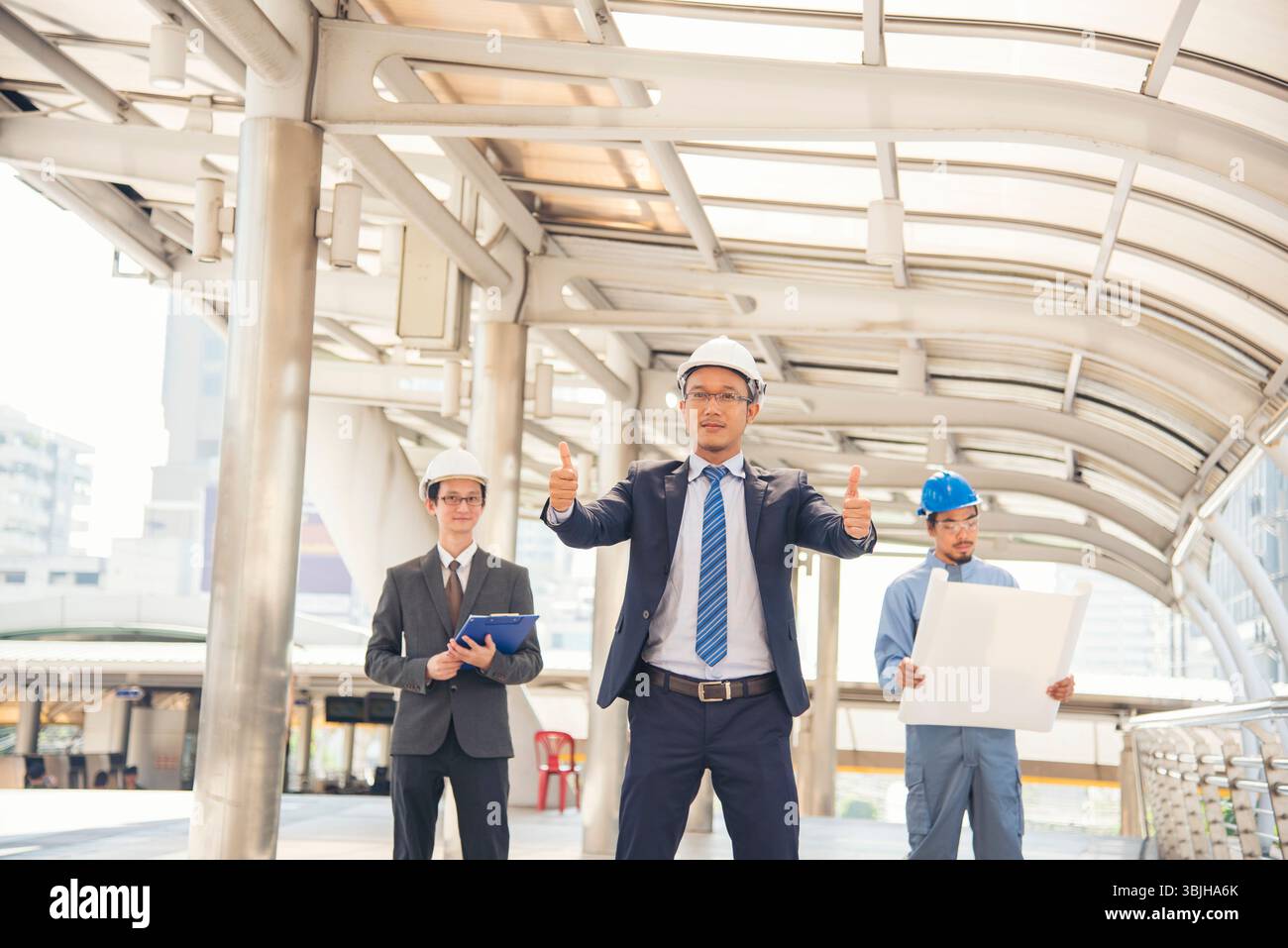 Civil engineer teams meeting working together wear worker helmets hardhat on construction site ...
