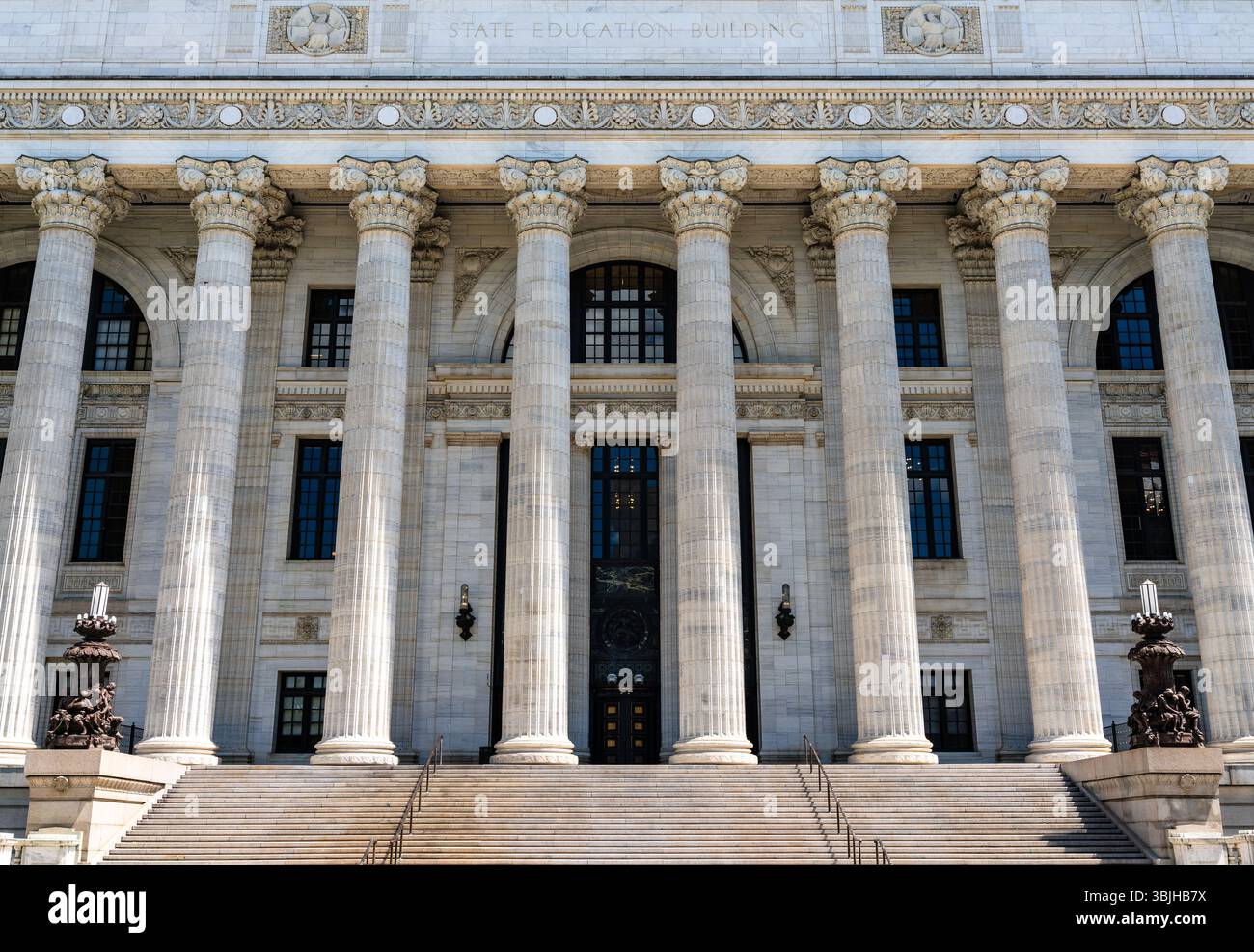 Massive Corinthian columns line the marble facade of the New York State ...