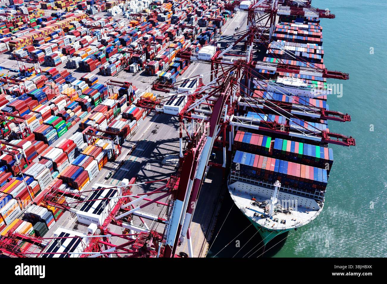 QINGDAO, CHINA - JUNE 16, 2025 - A cargo ship is loading and unloading ...