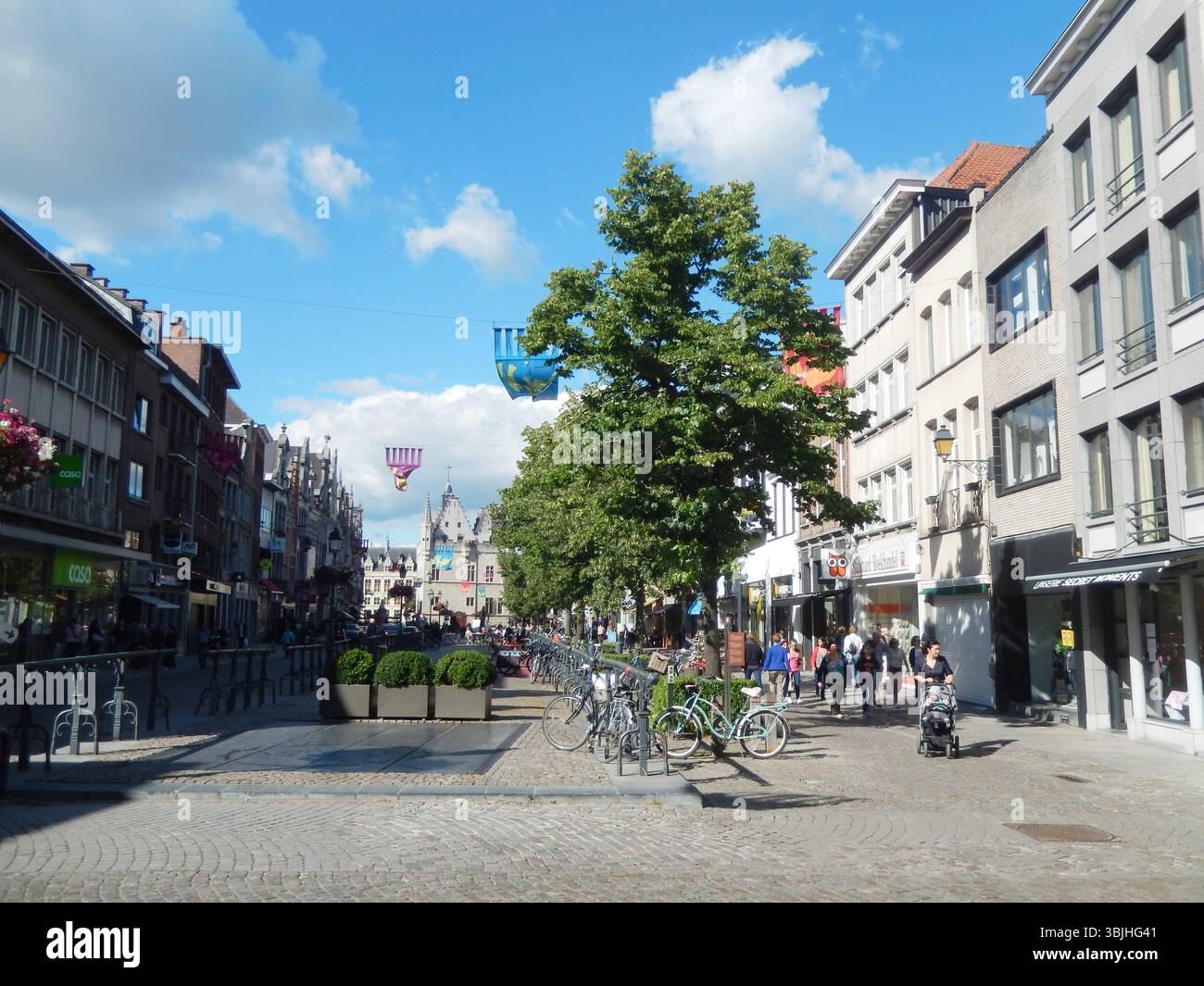 Charming European City Street with People, Shops, and Colorful ...