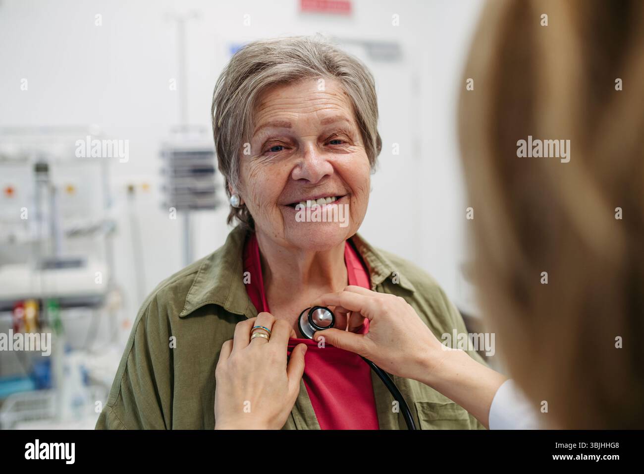 Geriatrician doctor examining elderly patient with stethoscope Stock ...