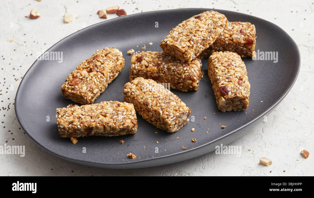 Nut bars on a dark grey oval plate – a healthy, crunchy plant-based ...