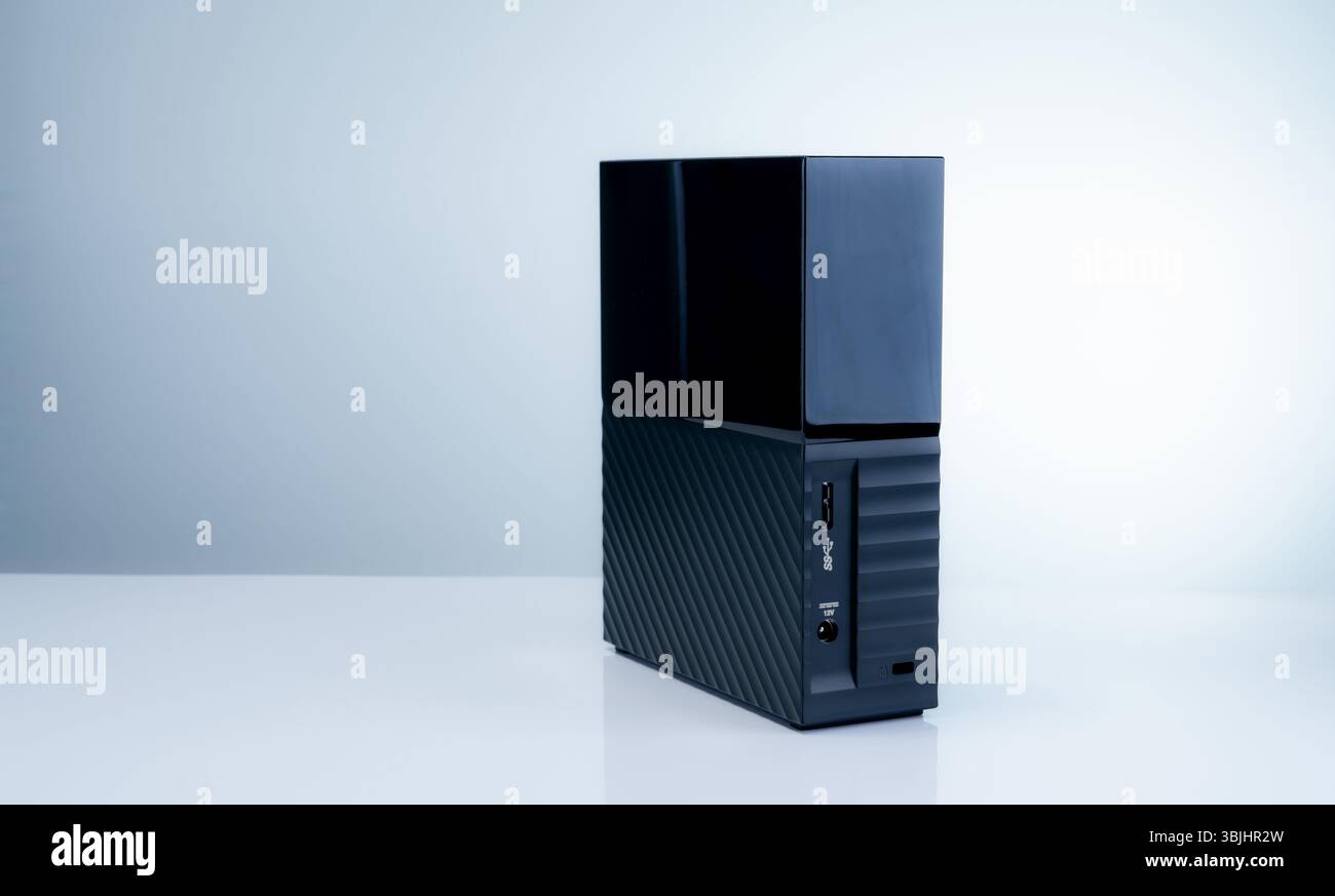 Black solid state external hard drive on white background, perfect for digital data storage and ...