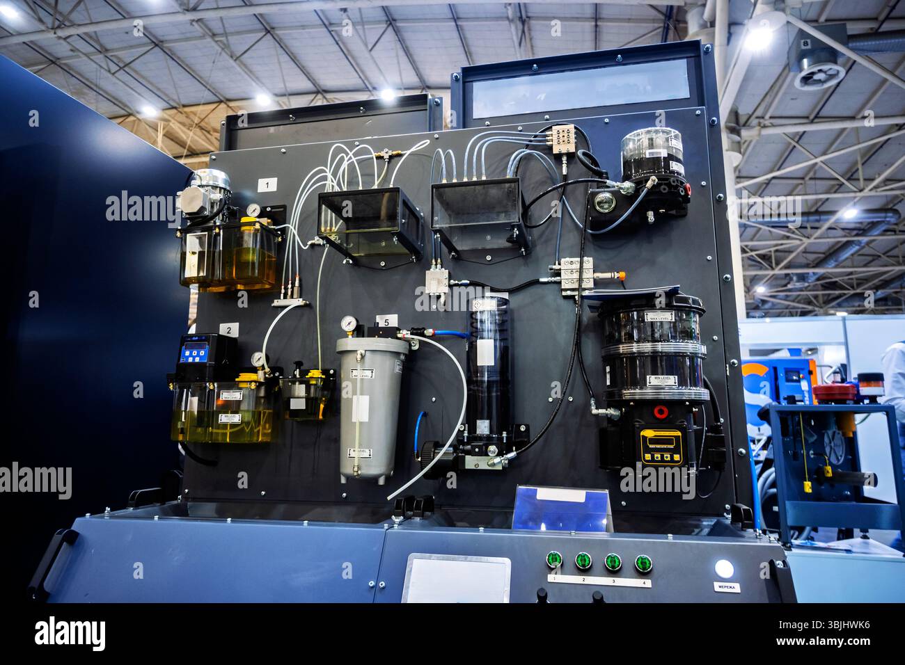 Detail of industrial lubrication equipment showing translucent oil ...