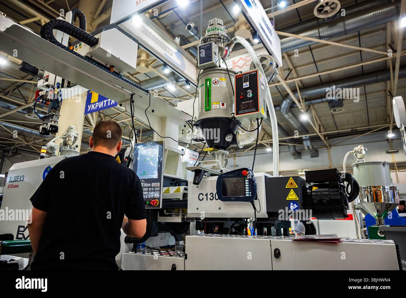 Ukraine, Kyiv - May, 27, 2025:Man operates modern industrial machine in ...