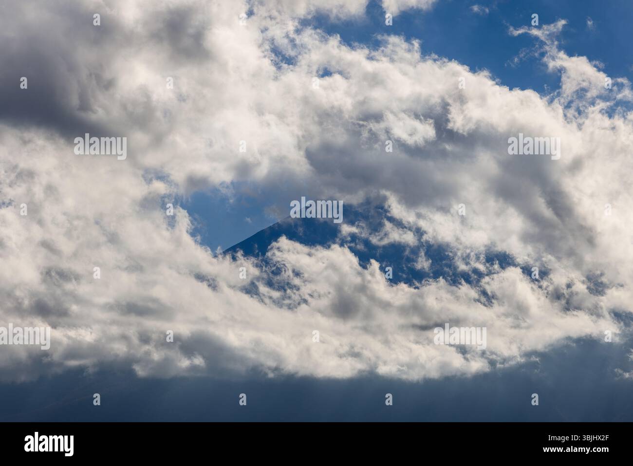 Hidden view of Mount Fuji’s peak in Japan emerges through thick clouds ...
