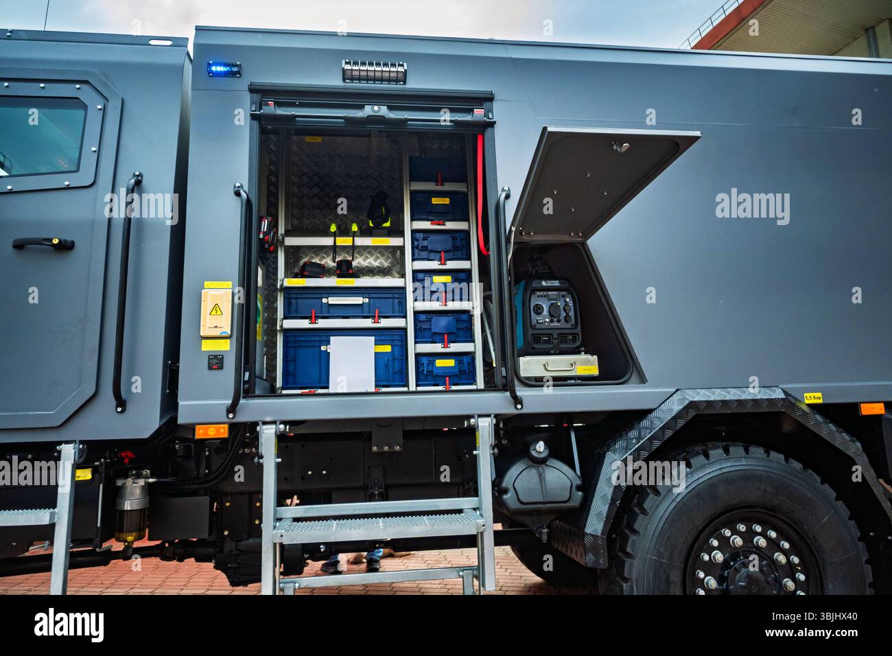 Armored demining vehicle with open equipment compartment, showcasing ...