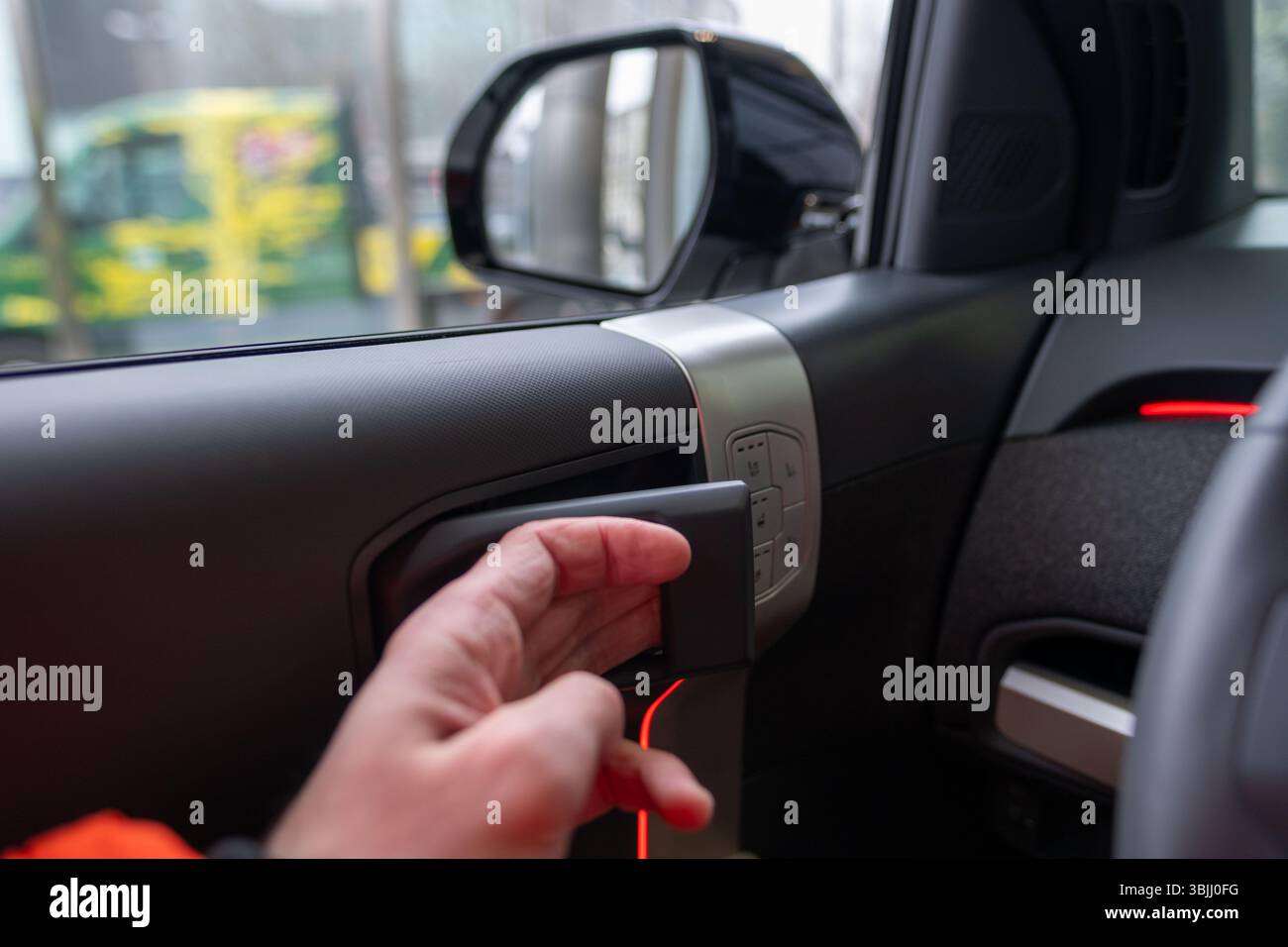 Kia EV6 GT-line car door panel, male driver's hand and electric ...