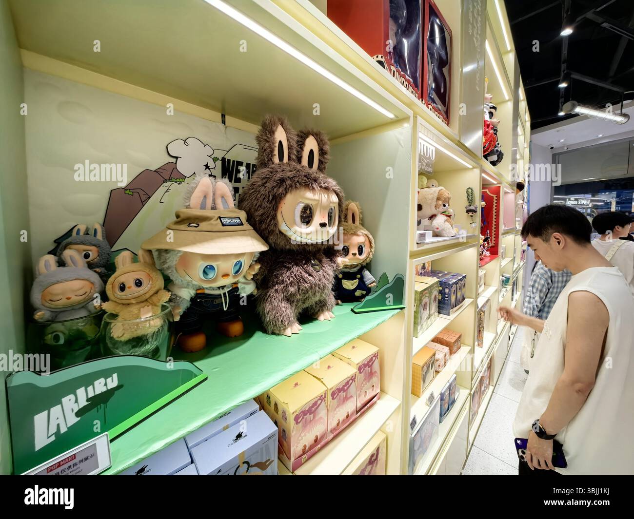 Customers buy Labubu products at a Pop Mart store in Beijing, China, 12 ...