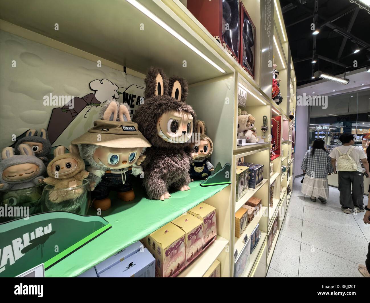 Customers buy Labubu products at a Pop Mart store in Beijing, China, 12 ...