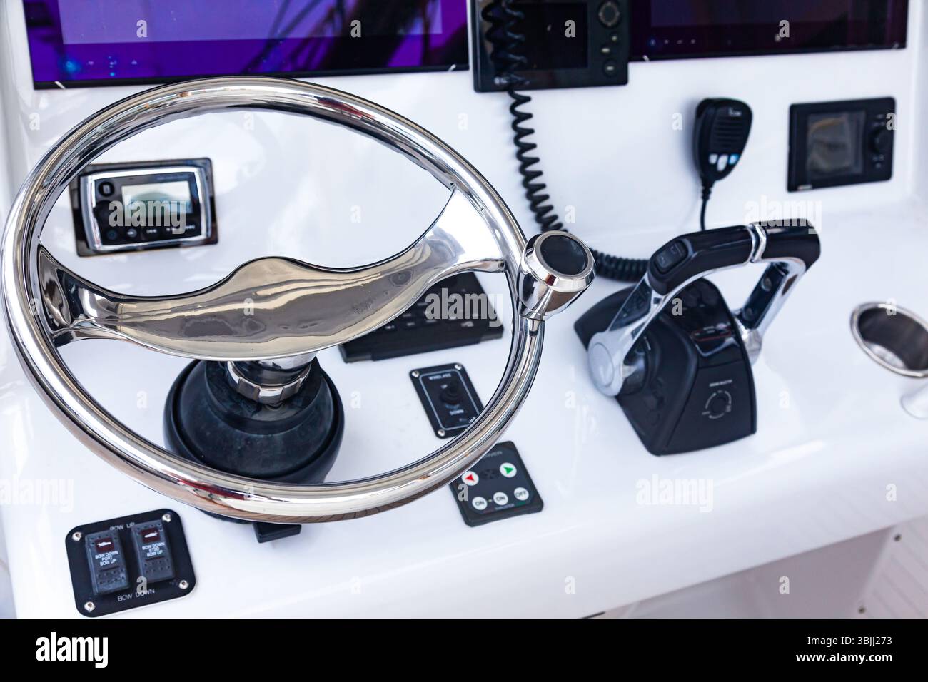 Luxury yacht control panel with steering wheel, gear levers, navigation ...