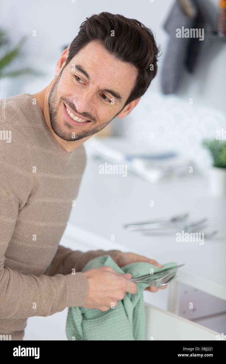 Man drying dishes in kitchen hi-res stock photography and images - Alamy