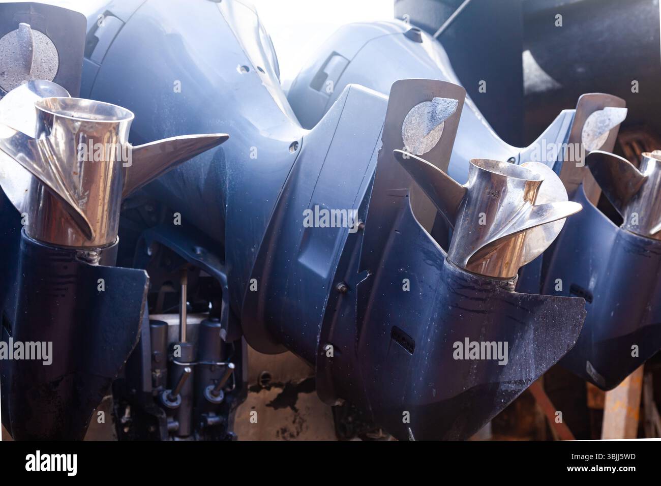 Three outboard motors mounted on the stern of a motor boat, bottom view ...