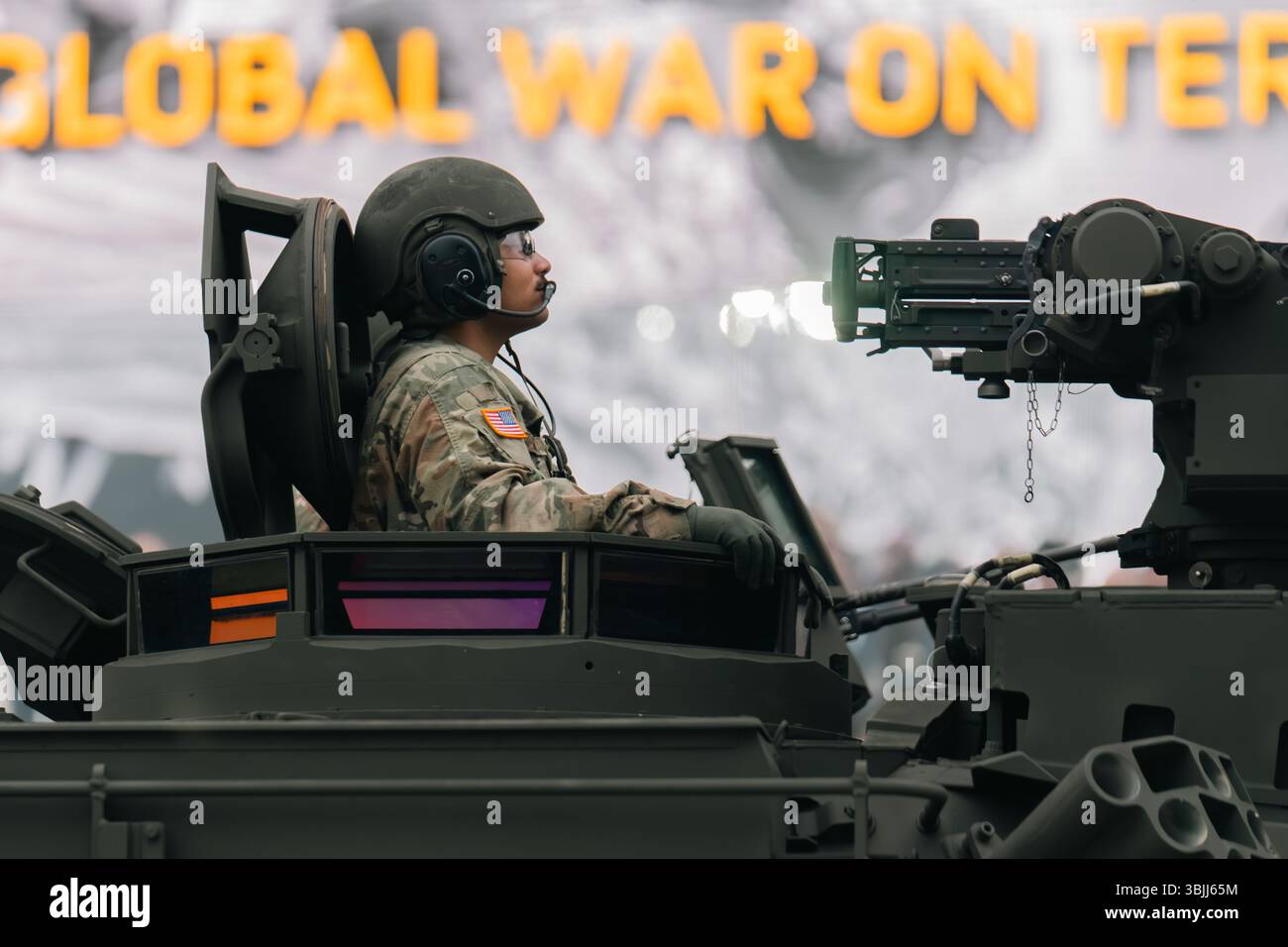 A U.S. Army Soldier looks forward while riding in an M1A2 Abrams tank ...