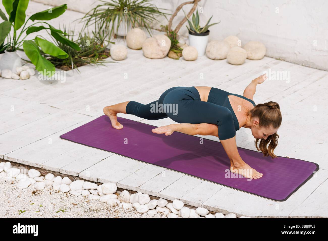 Fitness woman demonstrating advanced yoga hi-res stock photography and ...