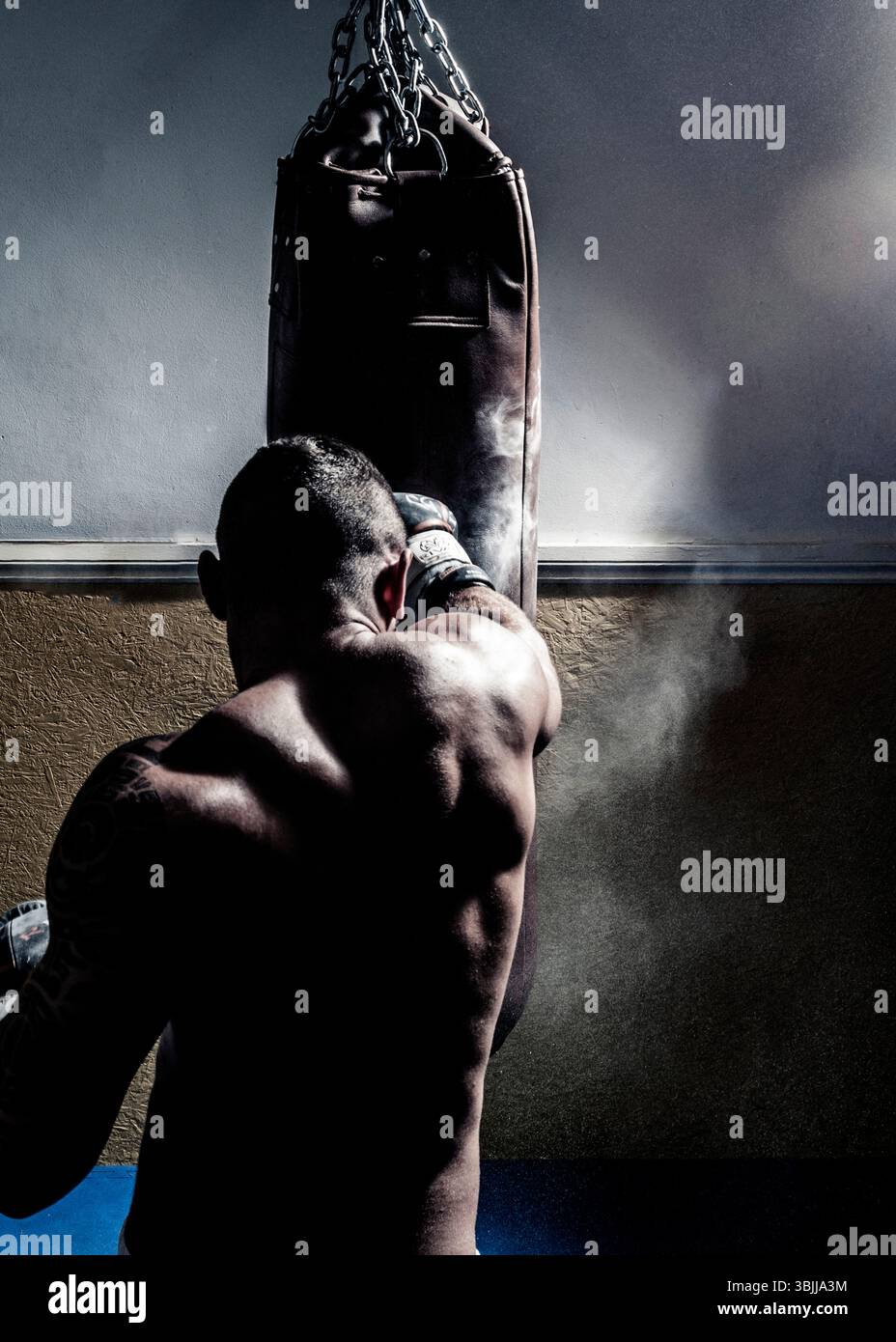 A muscular male boxer with a tattoo on his left shoulder is shown from ...