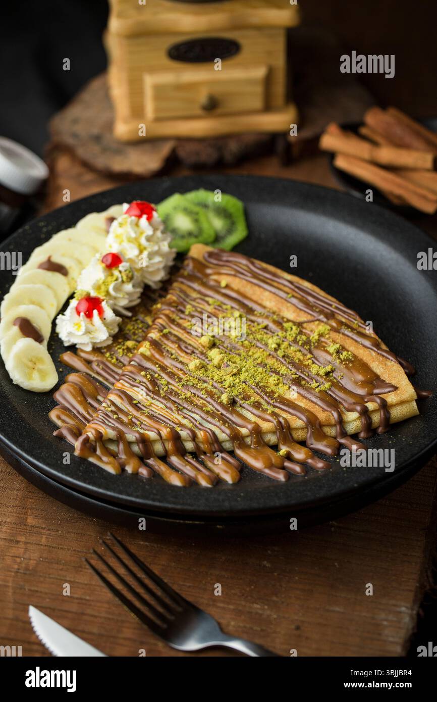 Hazelnut chocolate crepe in triangle shape, dark background Stock Photo ...