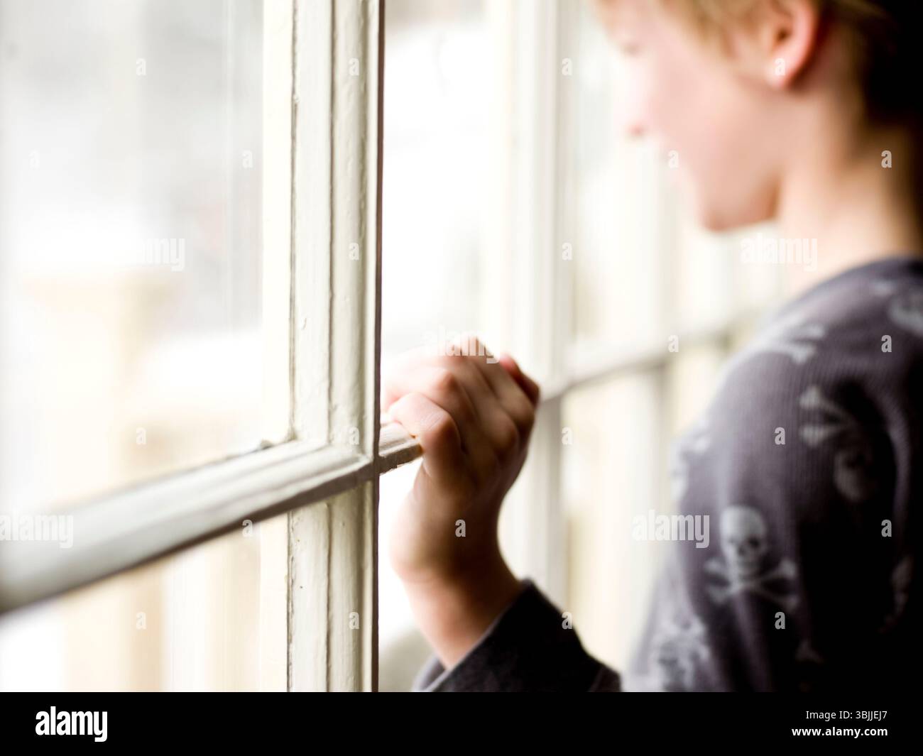 boy looks out window Stock Photo - Alamy