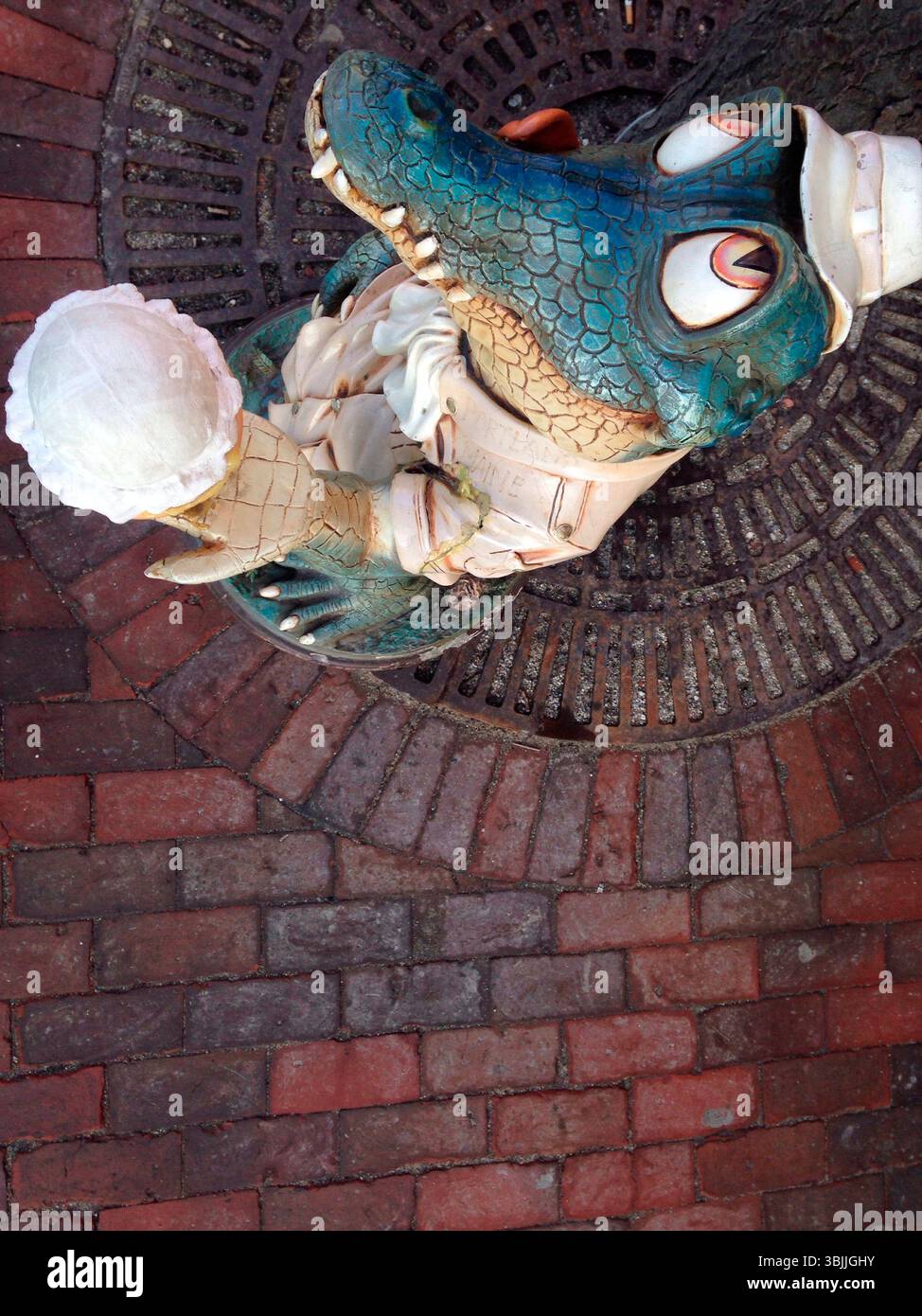 A statue of an alligator holding ice cream at Captain Sam's Ice Cream ...