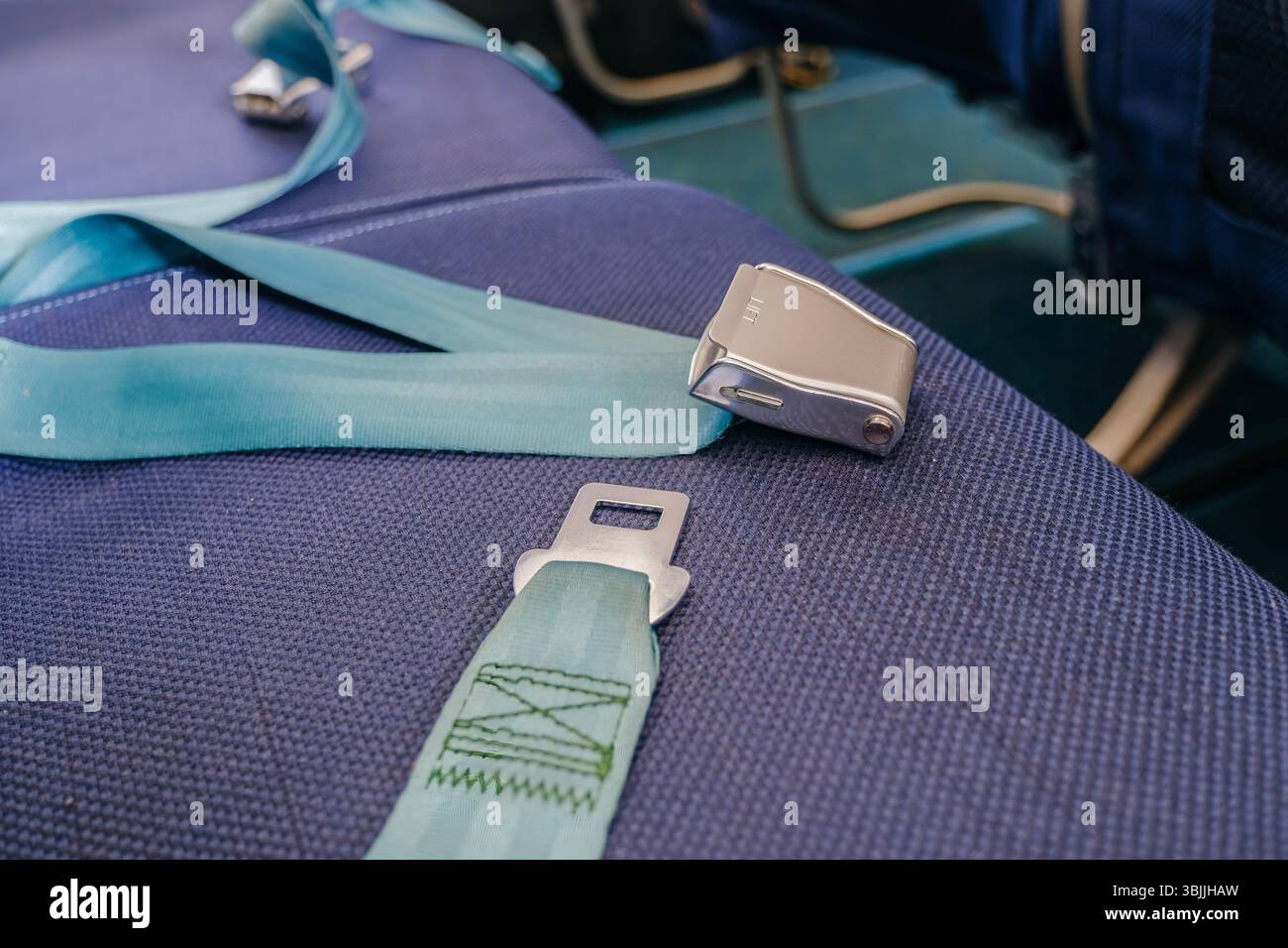 Close Up of Airplane Seat Belt Buckle and Blue Fabric Seat. Commercial ...
