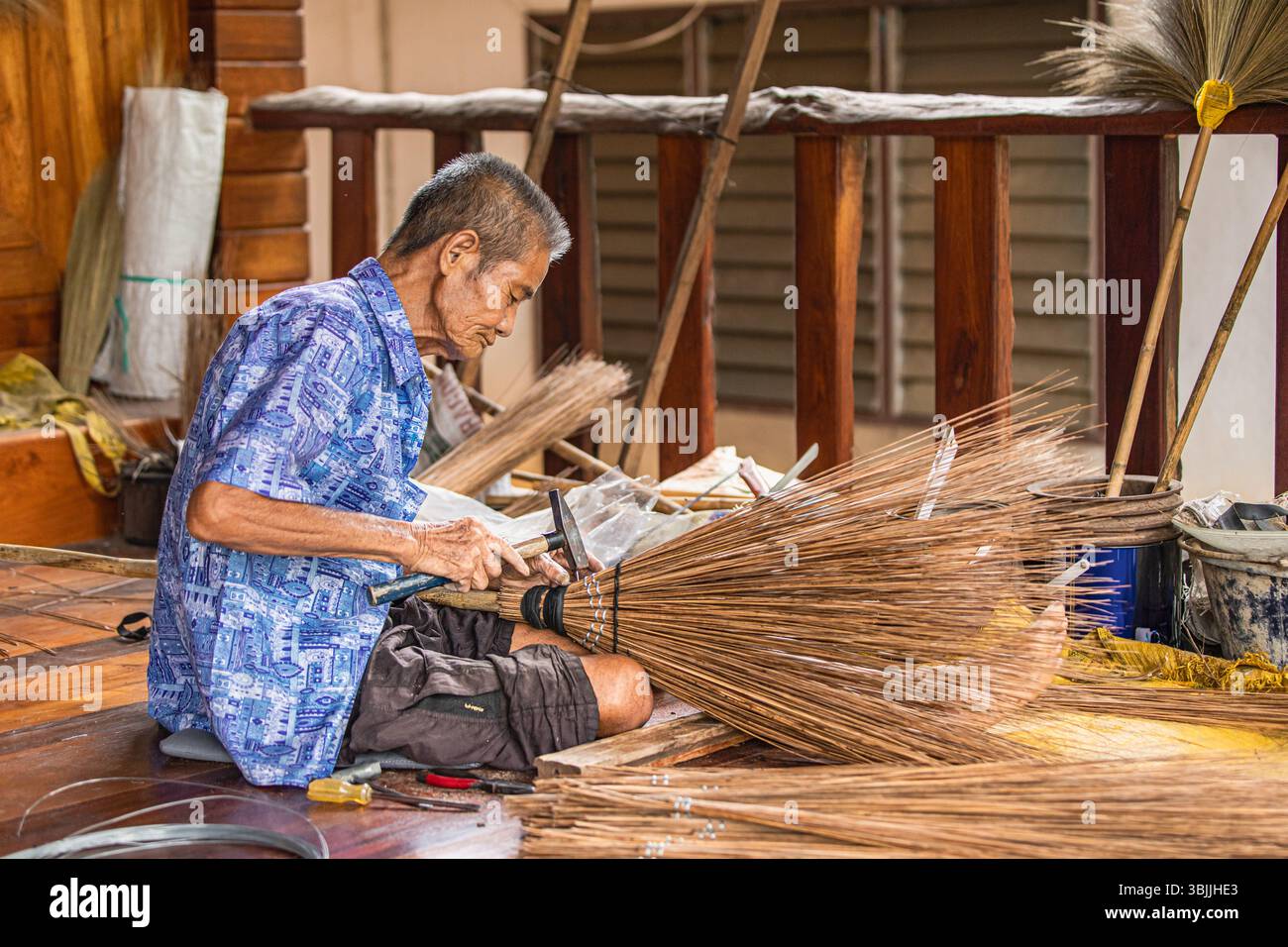 Craftsman hammering broom in traditional workshop Stock Photo - Alamy