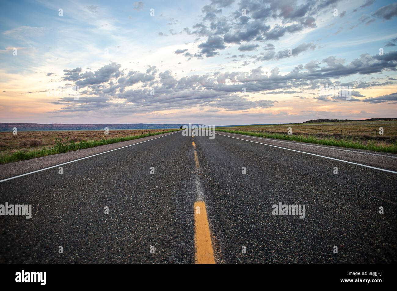 Open road low angle asphalt cloudy sky Stock Photo - Alamy