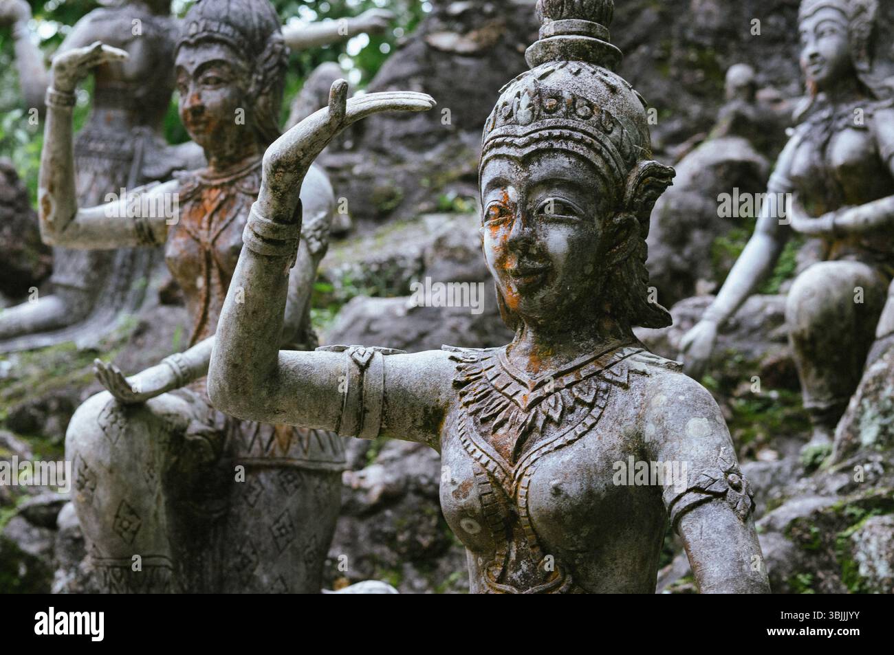 Ancient stone statues of dancing female deities in a forest temple ...