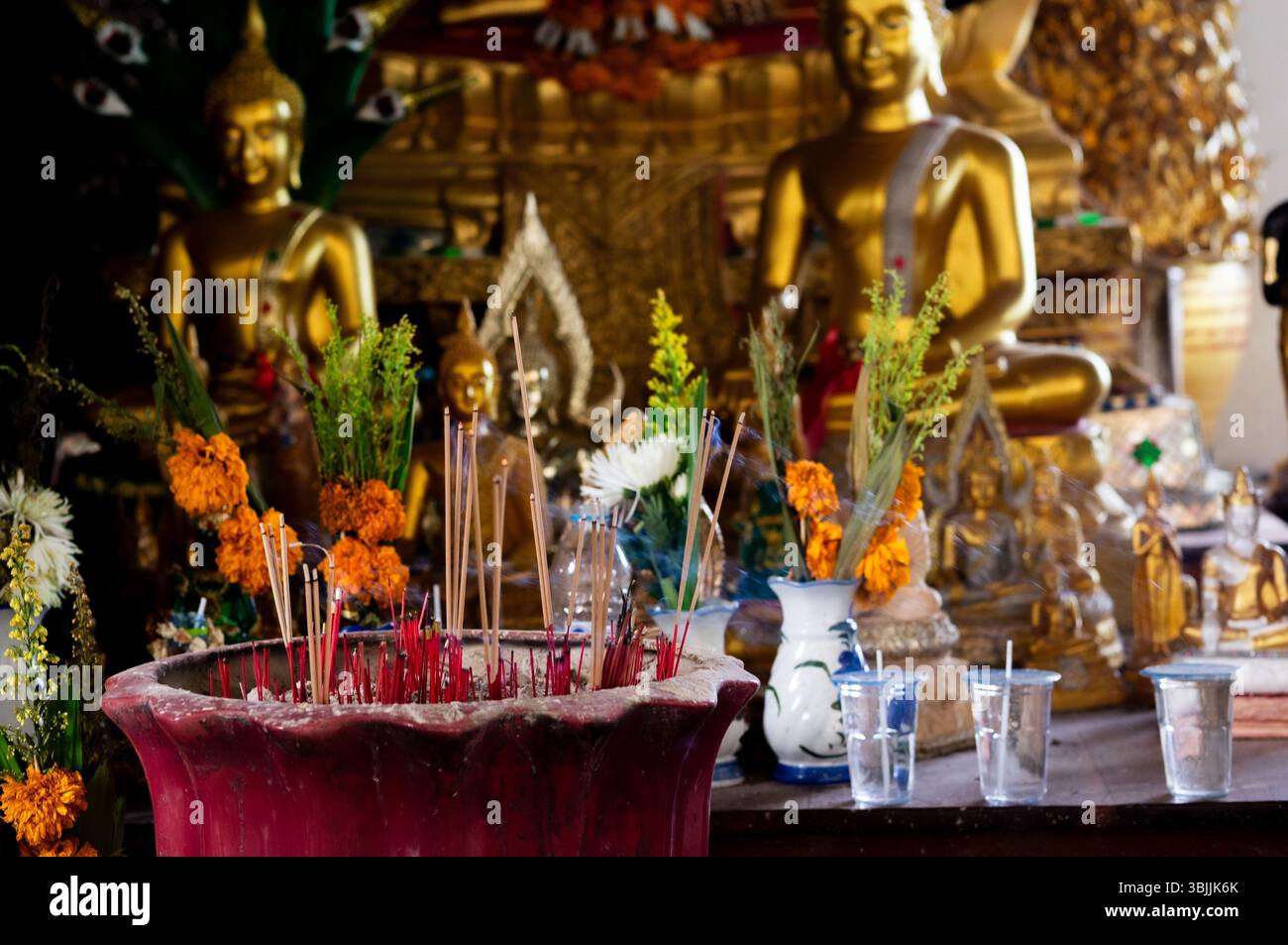 Buddhist shrine with incense and offerings Stock Photo - Alamy