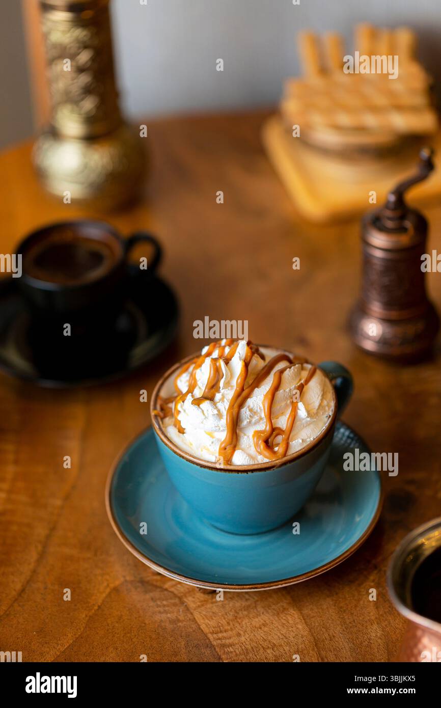 Cappuccino coffee with caramel cream topping, elegant drink Stock Photo ...