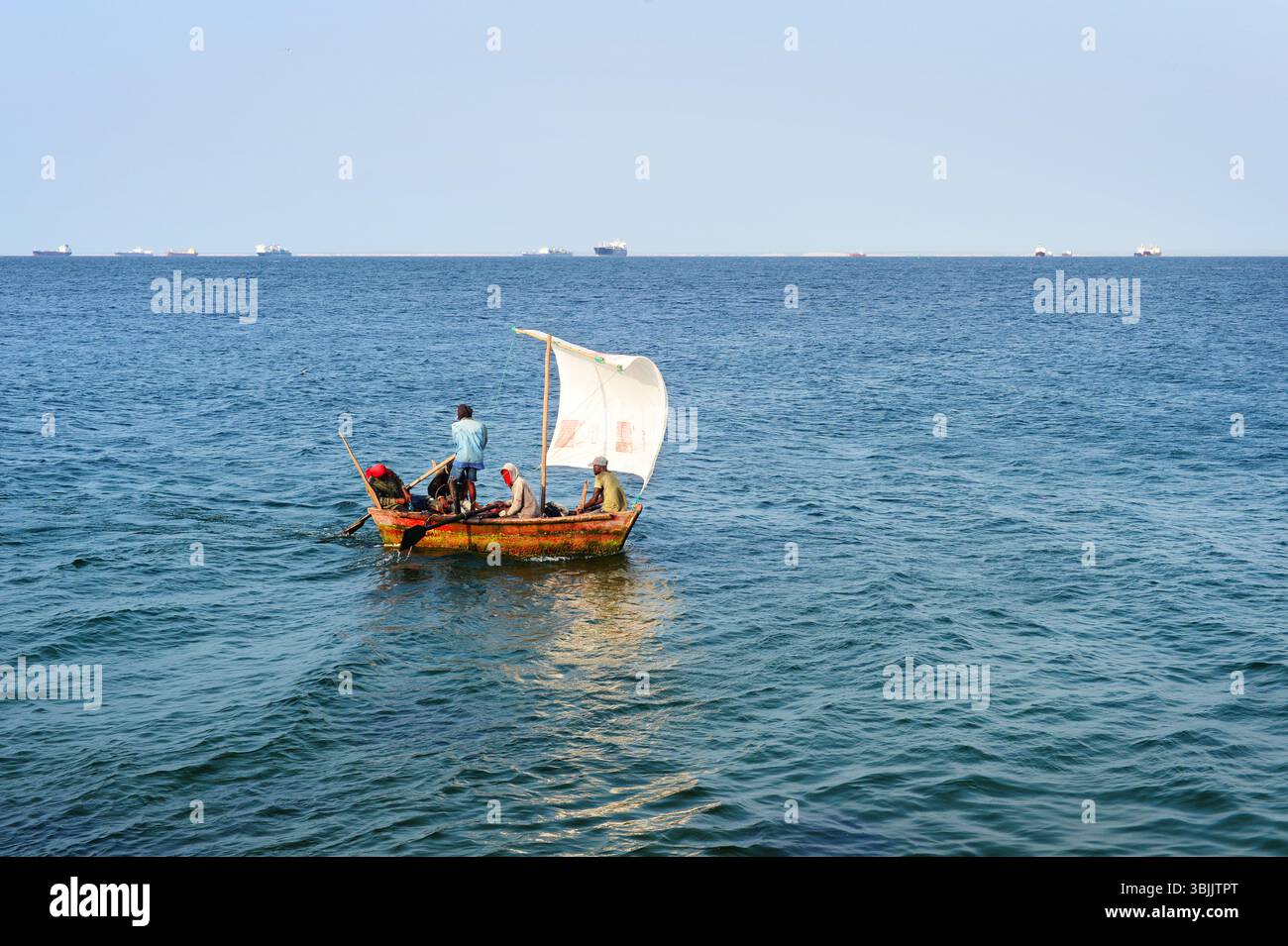 LUANDA, ANGOLA - FEB 03, 2025: People on a sail boat in the sea near ...