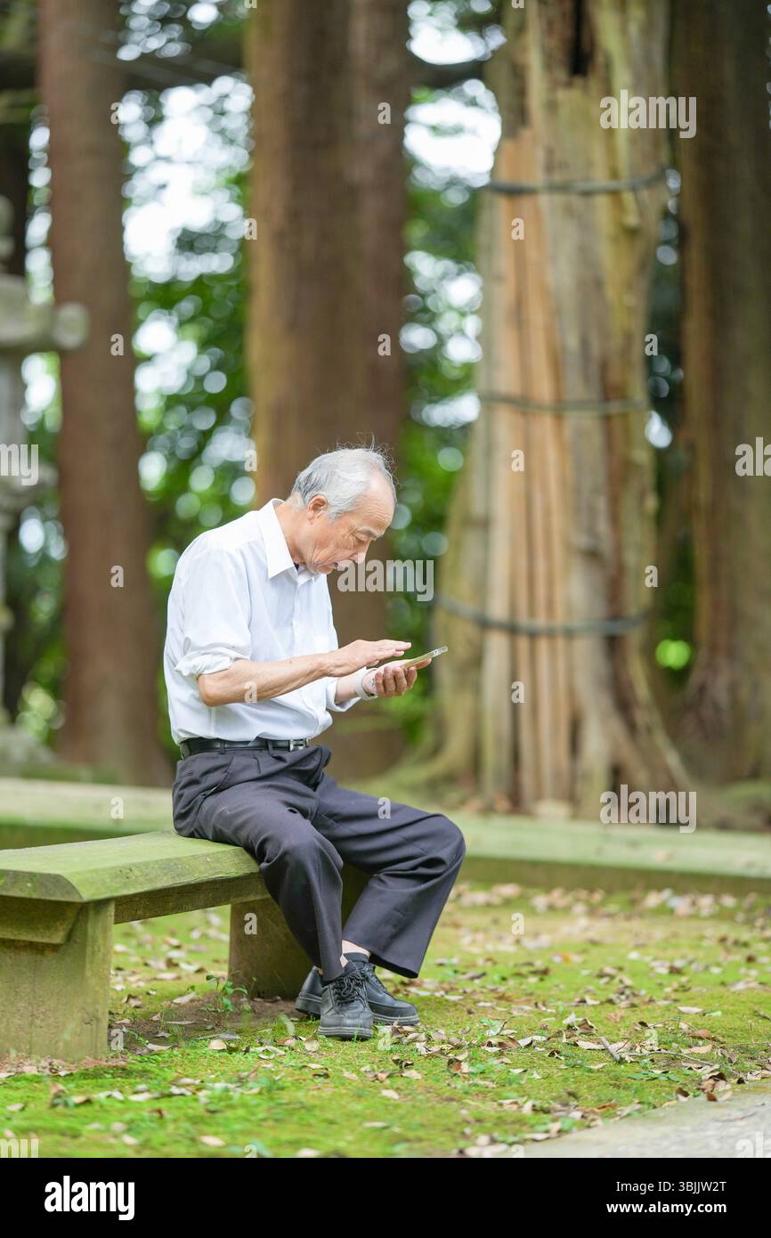 In rural Japan, a Japanese man in his late 70s sits at a peaceful ...