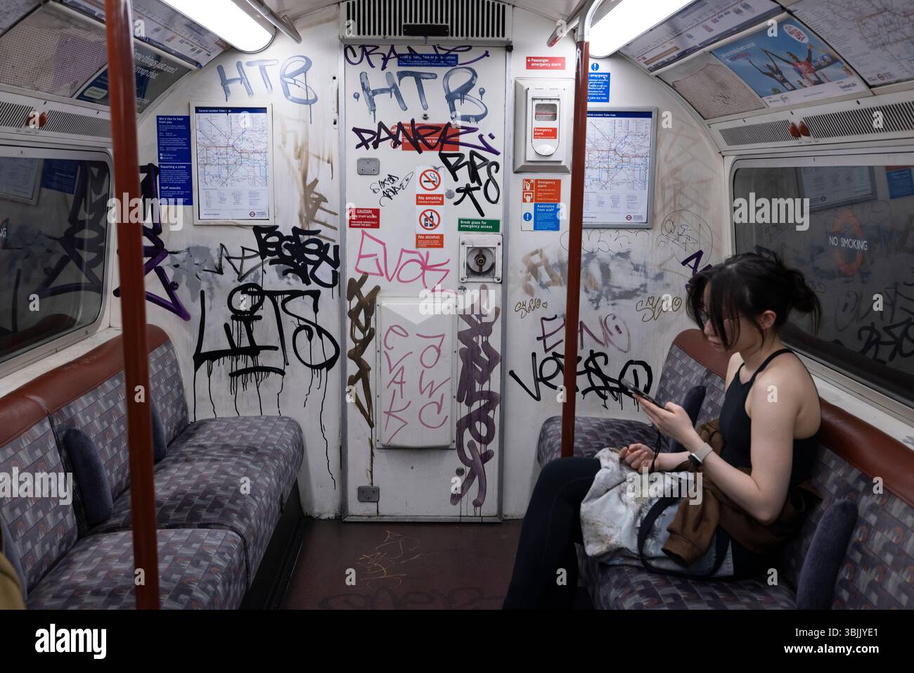 Passengers sitting on a Bakerloo line London Underground carriage which ...