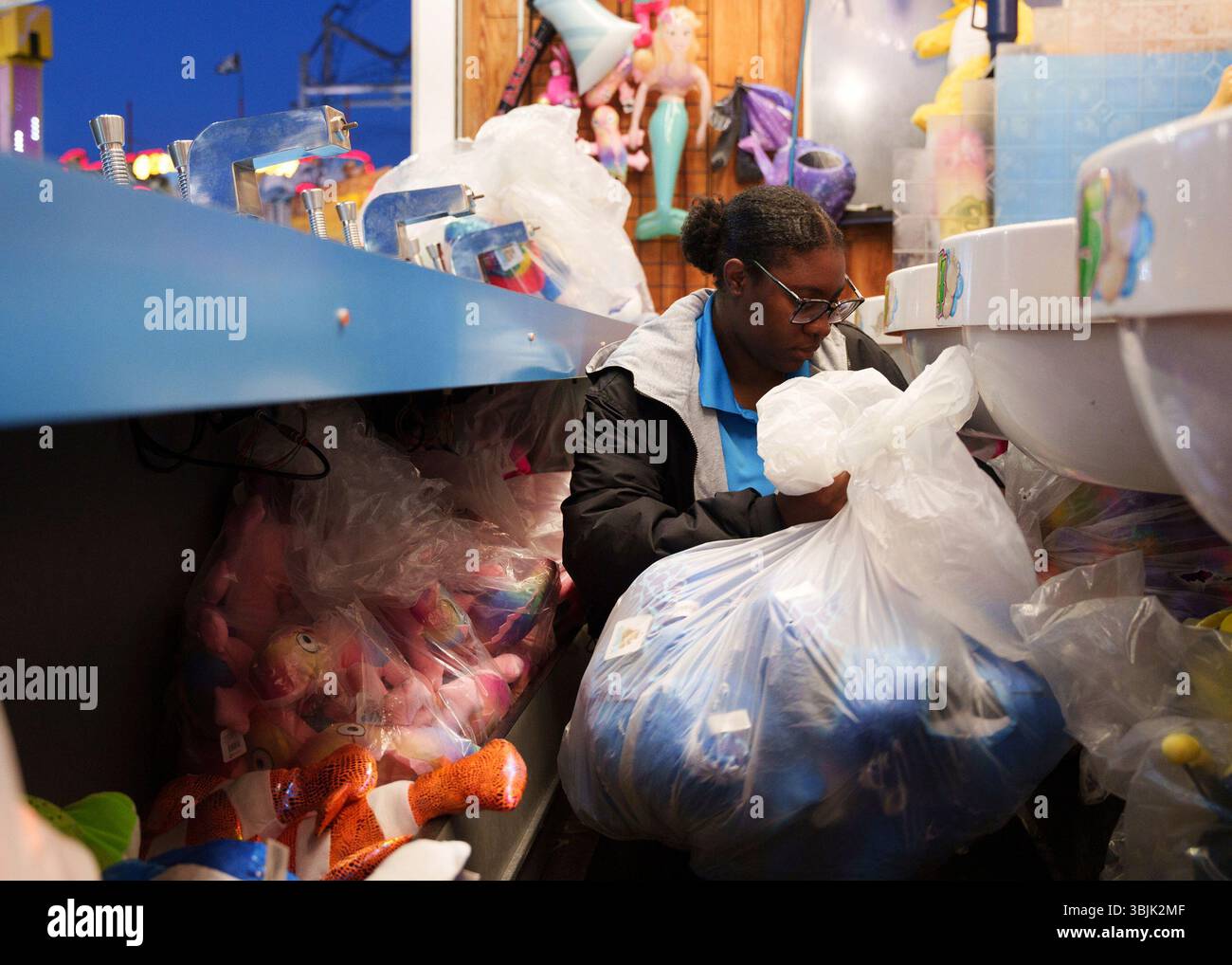 Playland's Castaway Cove booth operator Ja'Vira Blake restocks prizes ...