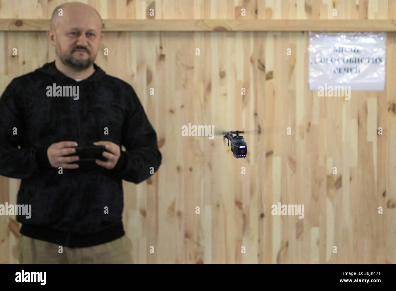 A man pilots a drone during a UAV lesson for the students of 10th-11th ...