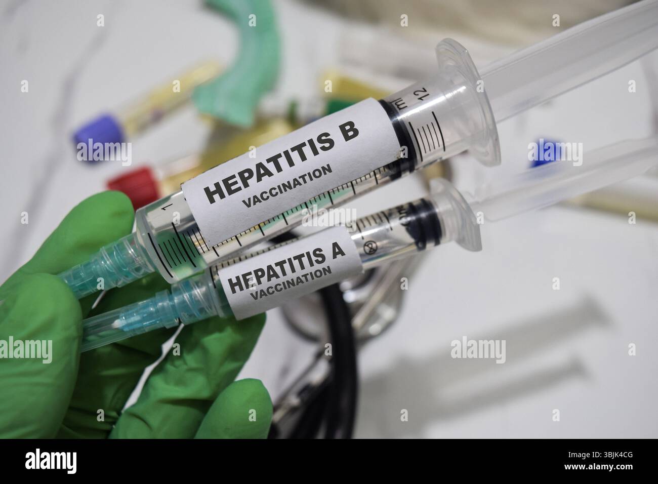 Hepatitis A and Hepatitis B vaccination drug syringe in green gloved ...
