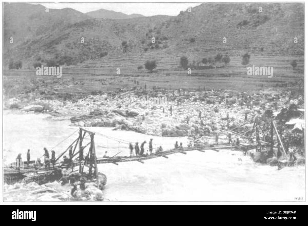 Photograph of the construction of a suspension bridge over the Panjkora ...